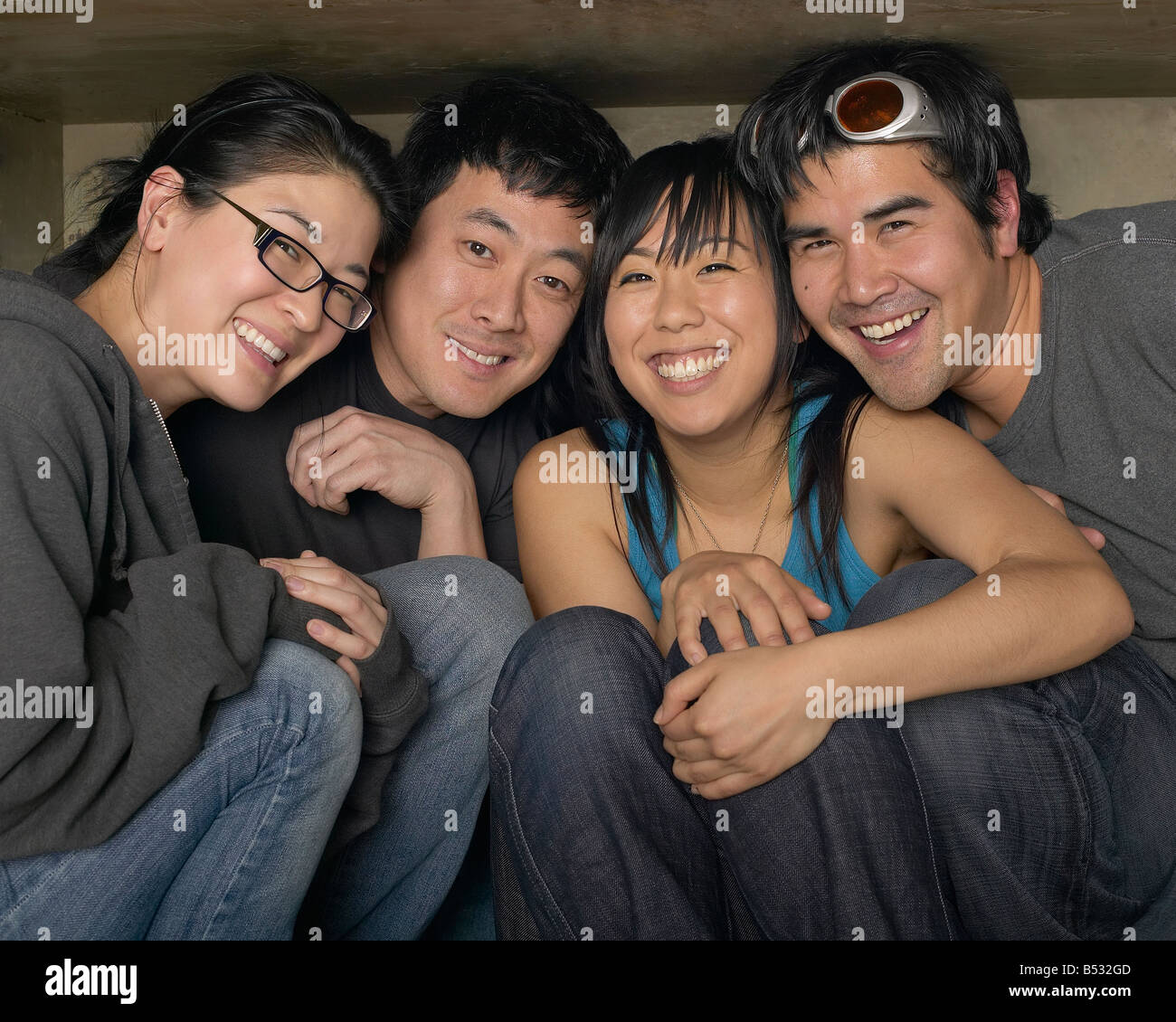 Multi-ethnic friends smiling Stock Photo - Alamy