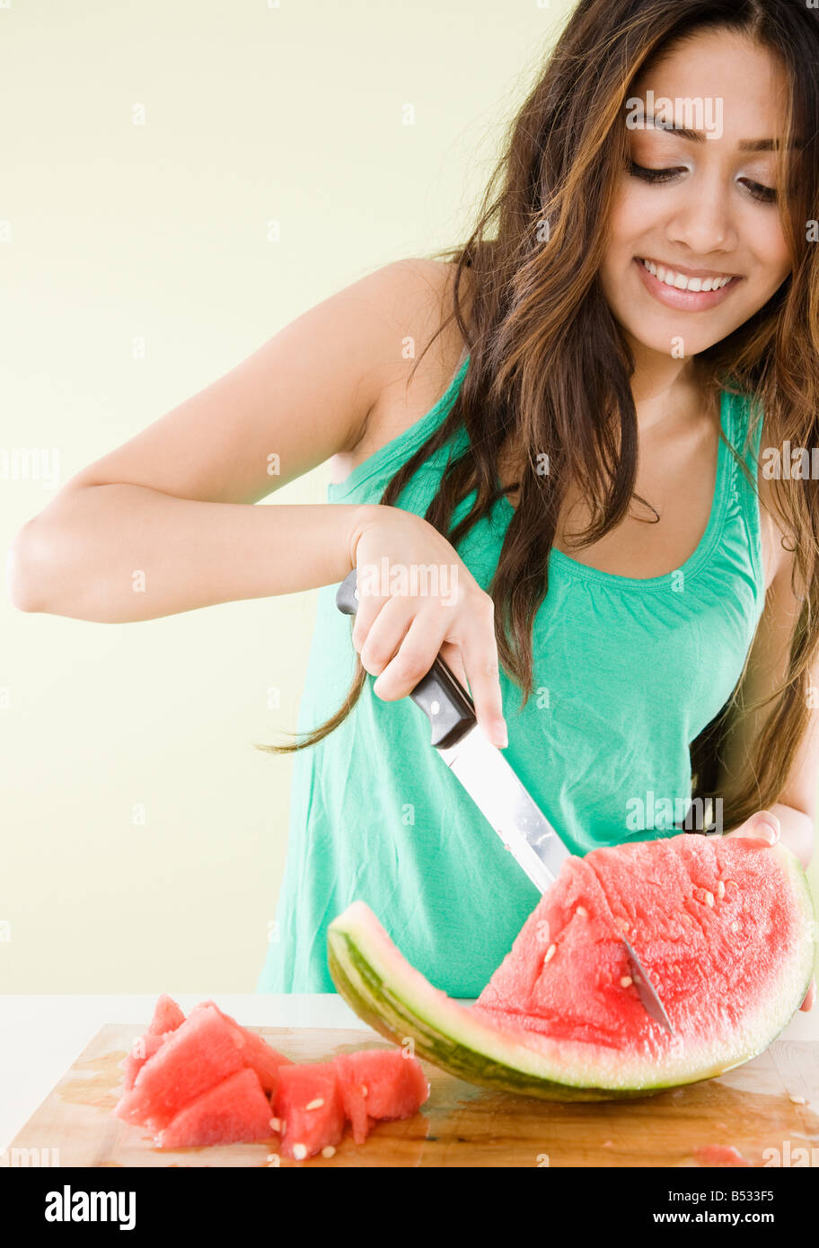 Middle Eastern woman cutting watermelon Stock Photo - Alamy