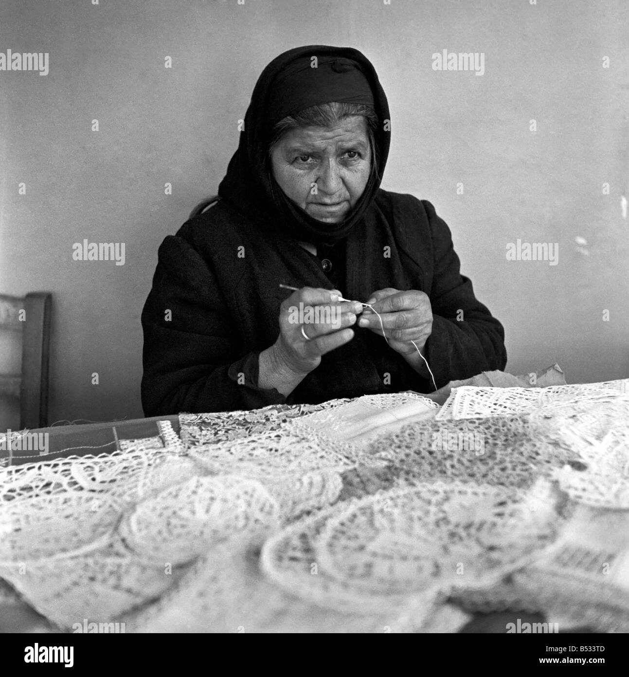 Old Greek Woman sewing lace at her stall in a Cyprus town market March ...