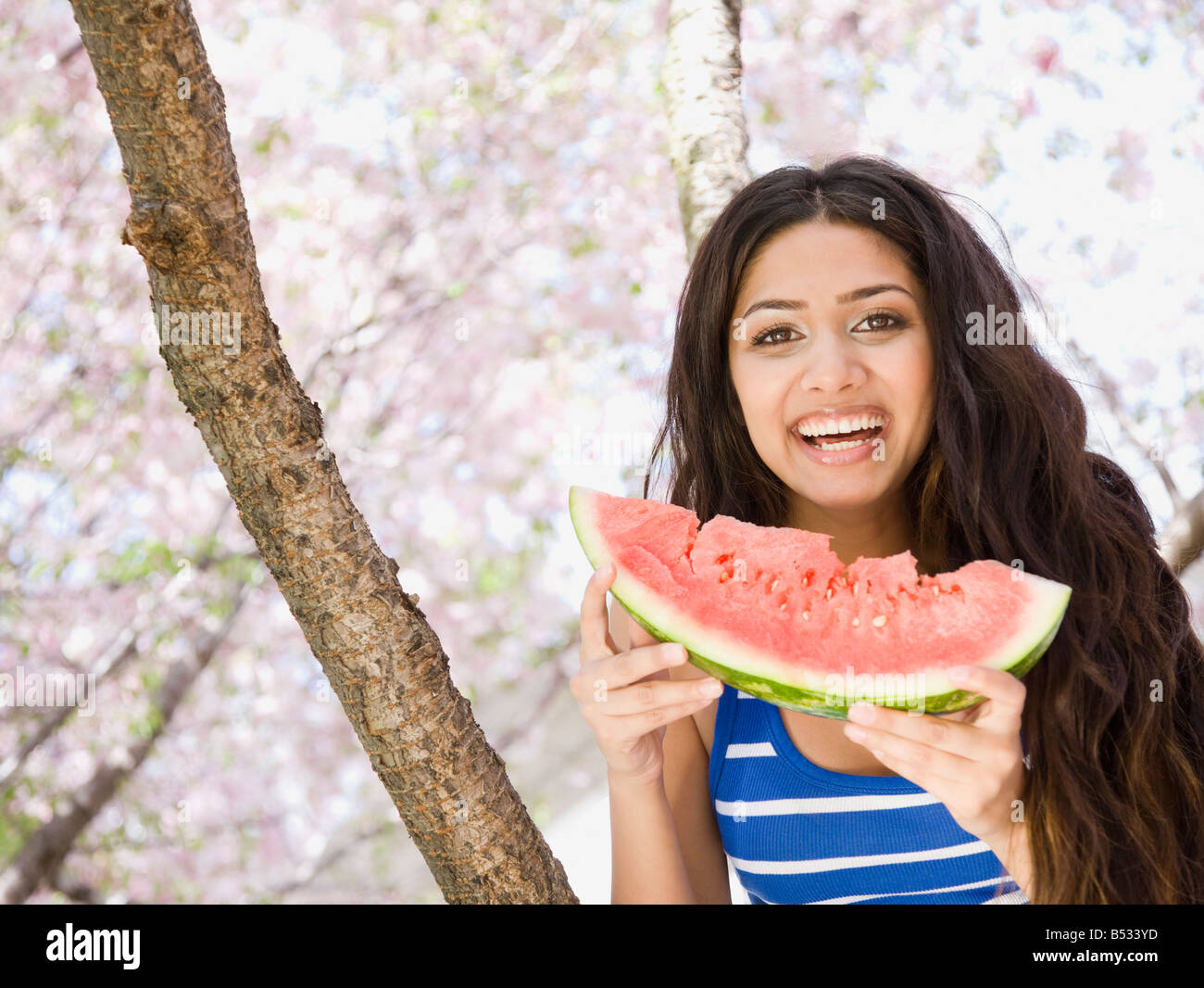 Middle Eastern woman eating watermelon Stock Photo - Alamy