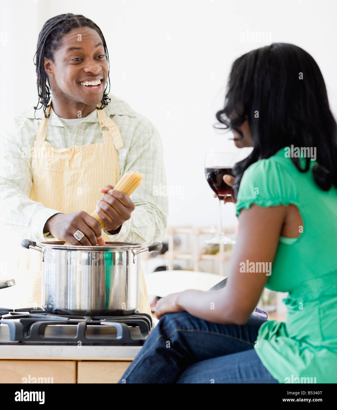 African couple cooking in kitchen Stock Photo - Alamy