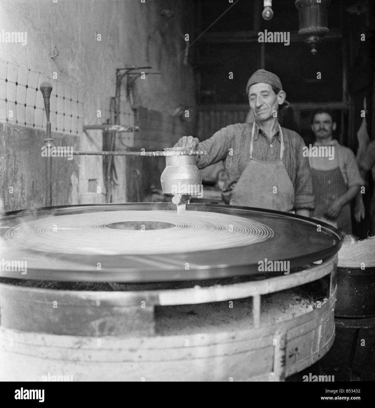 A baker making bread in a town in Cyprus. March 1952 C1297-006 Stock ...
