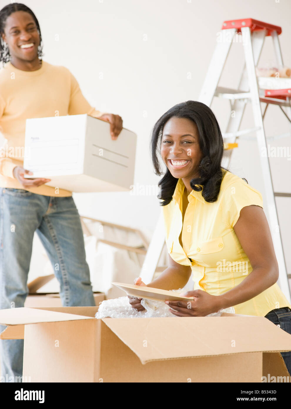 Adult african man packing boxes hi-res stock photography and images - Alamy