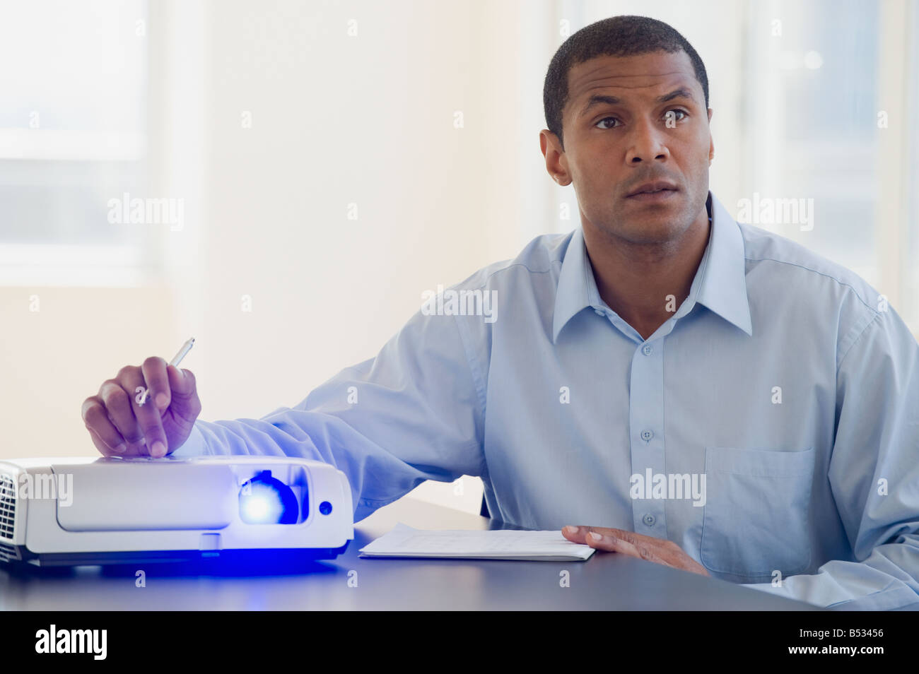African man working slide projector Stock Photo - Alamy