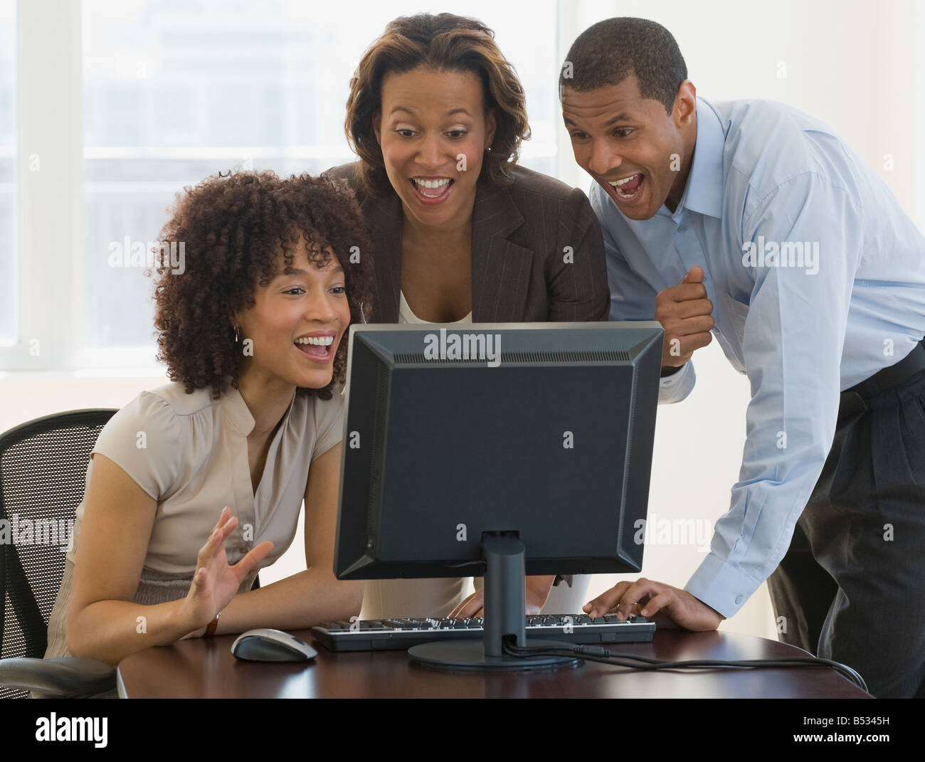 African people looking excited working on computer Stock Photo - Alamy