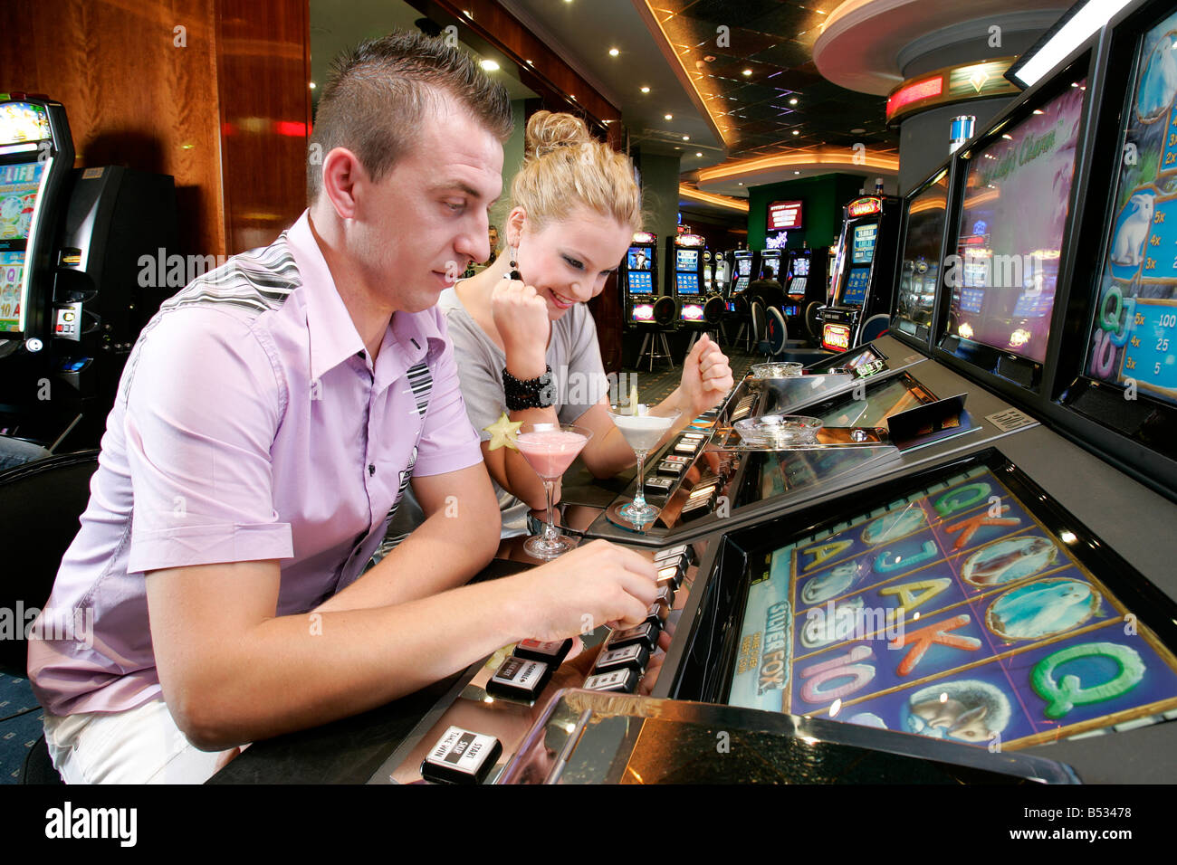 Girl playing fruit machine hi-res stock photography and images - Alamy