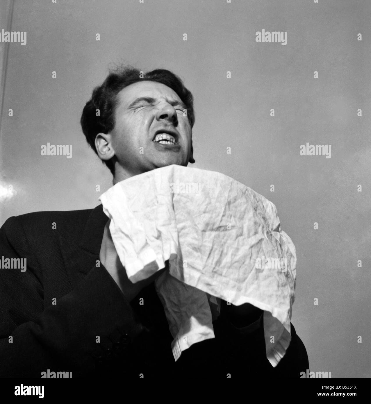 Man sneezing 1950s Black and White Stock Photos & Images - Alamy