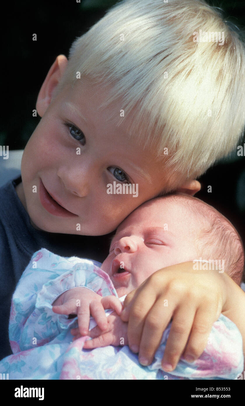little boy cuddling his newborn baby sister Stock Photo - Alamy