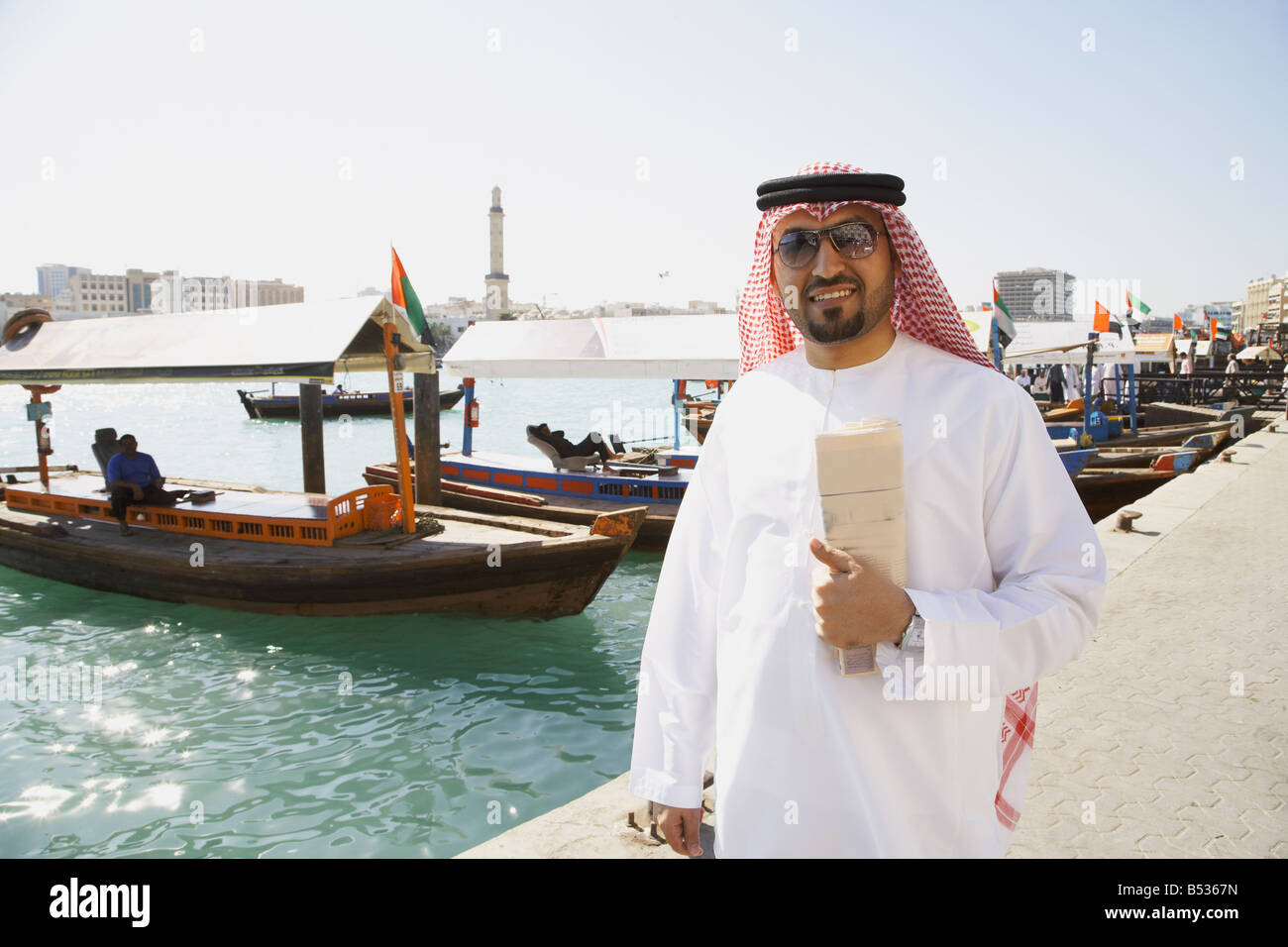 Arab man standing at waterfront Stock Photo - Alamy