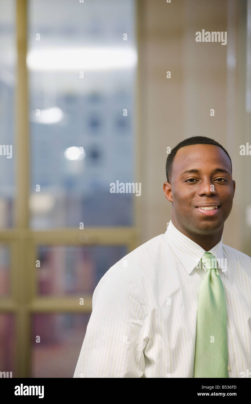 African businessman posing in office Stock Photo - Alamy