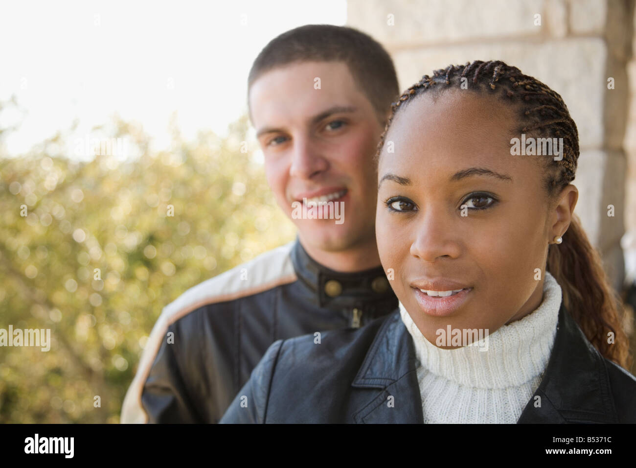 Multi-ethnic couple on balcony Stock Photo - Alamy