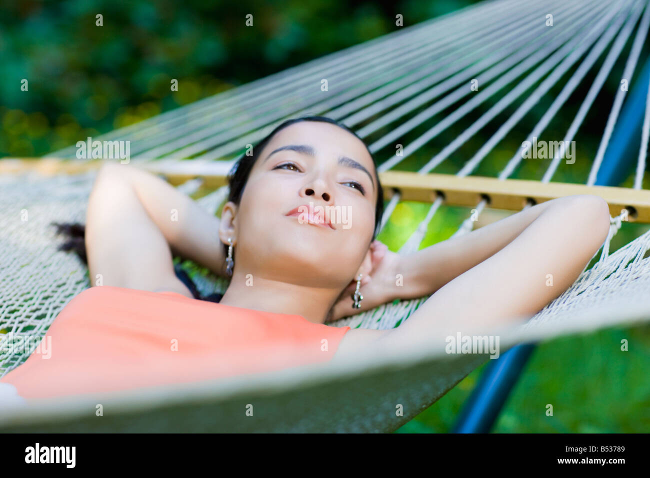 Hispanic woman laying in hammock Stock Photo - Alamy