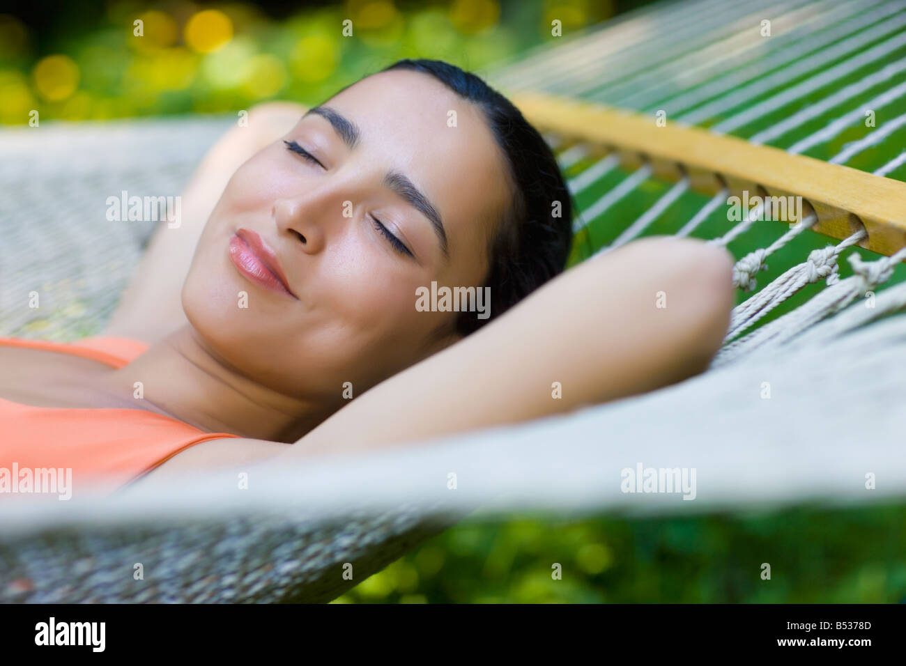 Hispanic woman laying in hammock Stock Photo - Alamy