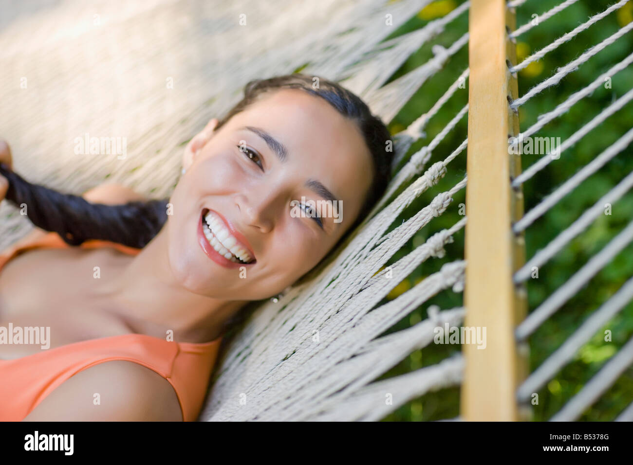 Hispanic woman laying in hammock Stock Photo - Alamy