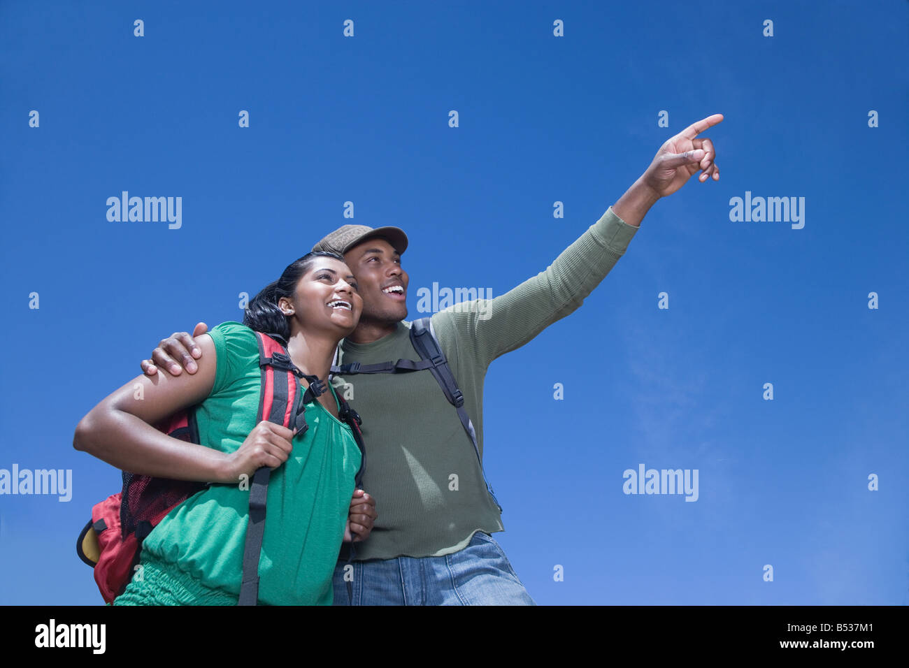 Multi-ethnic couple backpacking Stock Photo - Alamy