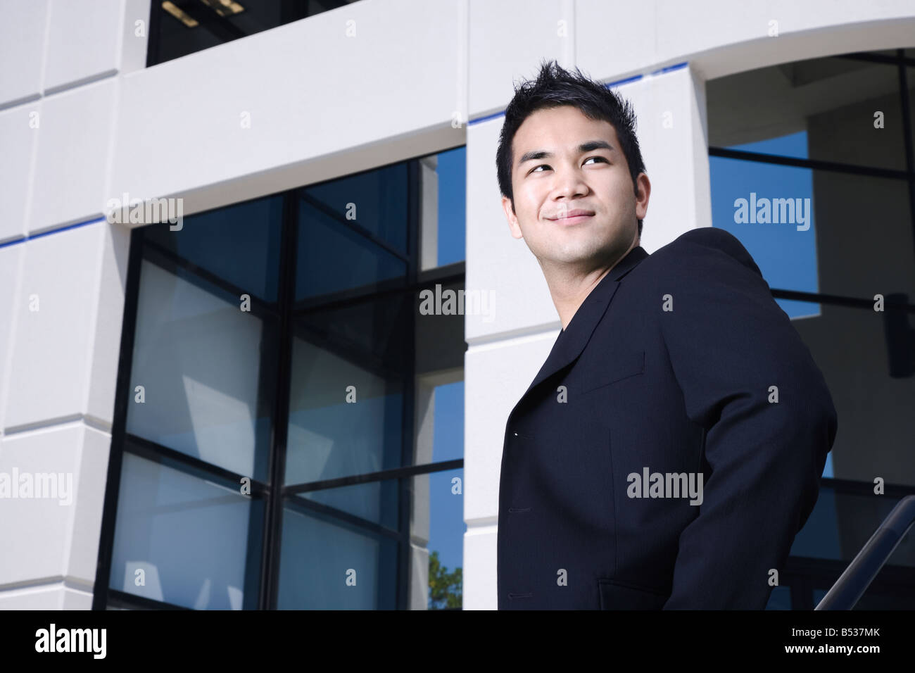 Asian businessman outside office building Stock Photo - Alamy