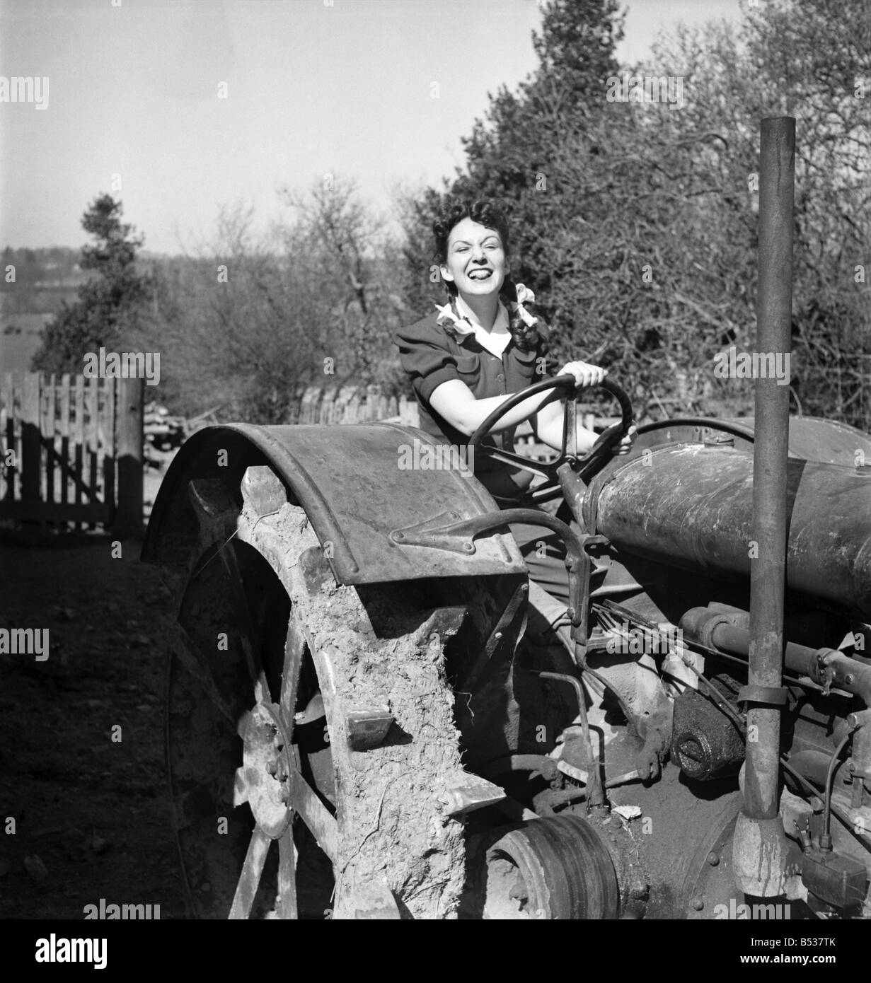 Jean Kent driving a tractor down on farm at Hartfield. March 1948 ...