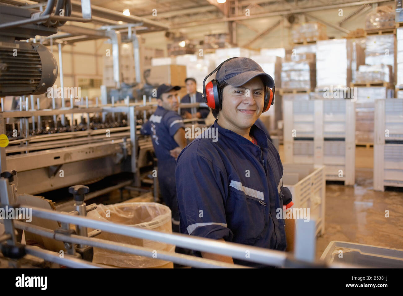 Hispanic man working in bottling factory Stock Photo - Alamy