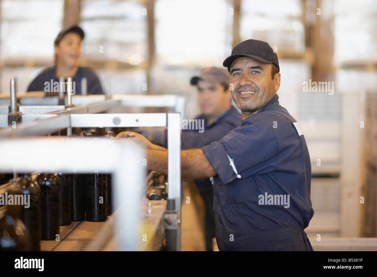 Hispanic man working in bottling factory Stock Photo - Alamy