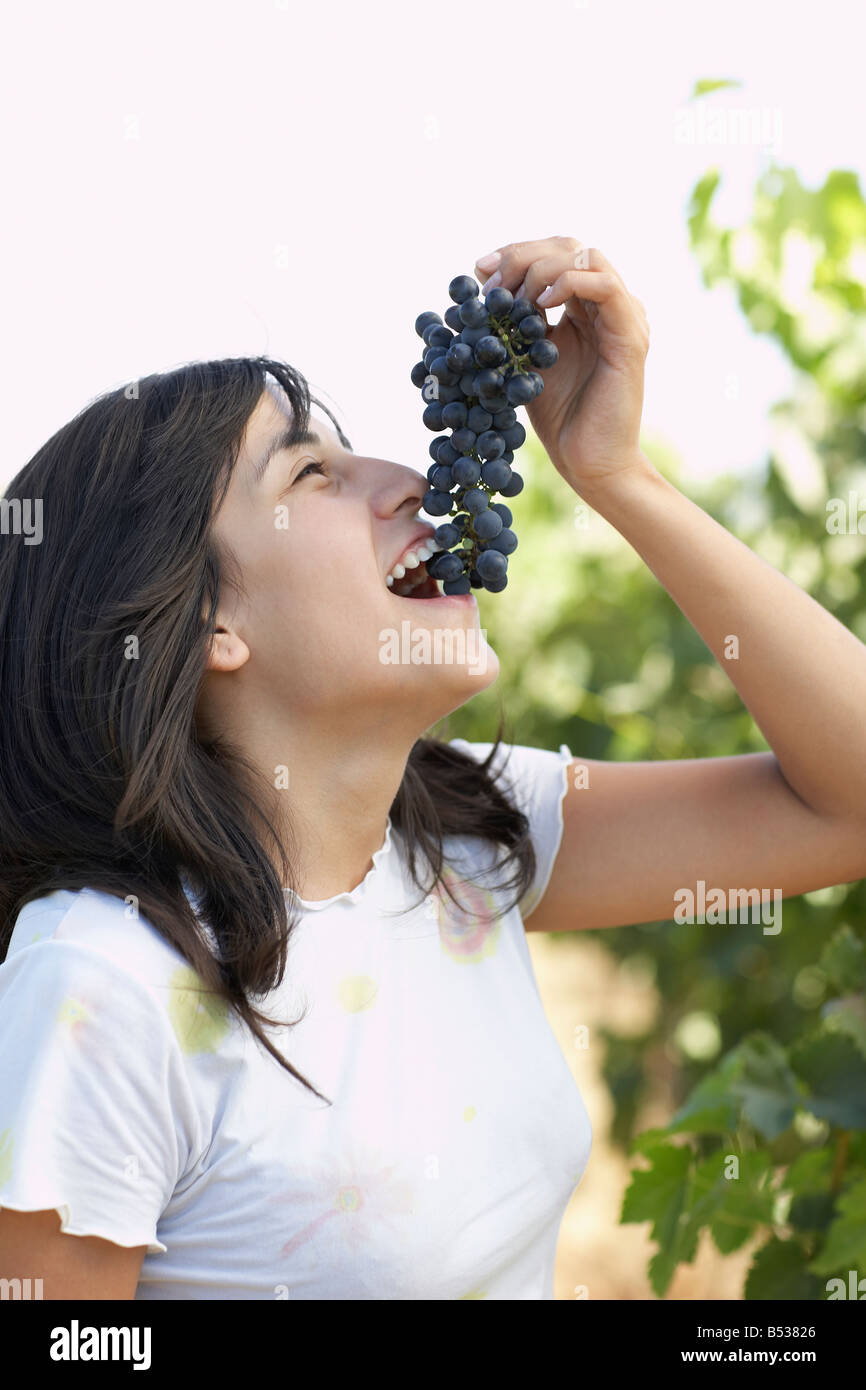 Hispanic woman eating red grapes in vineyard Stock Photo - Alamy