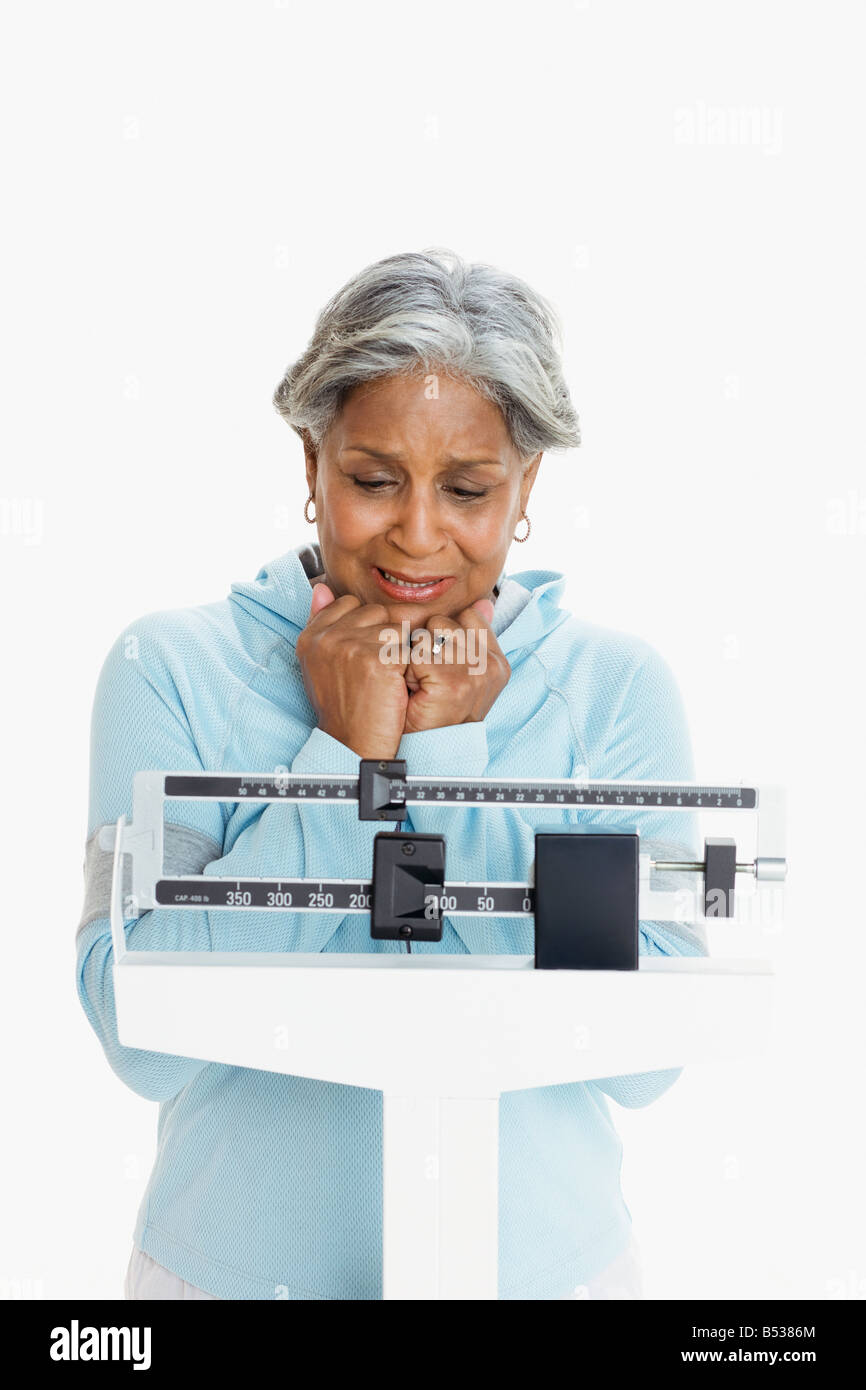 African woman weighing herself on scale Stock Photo - Alamy