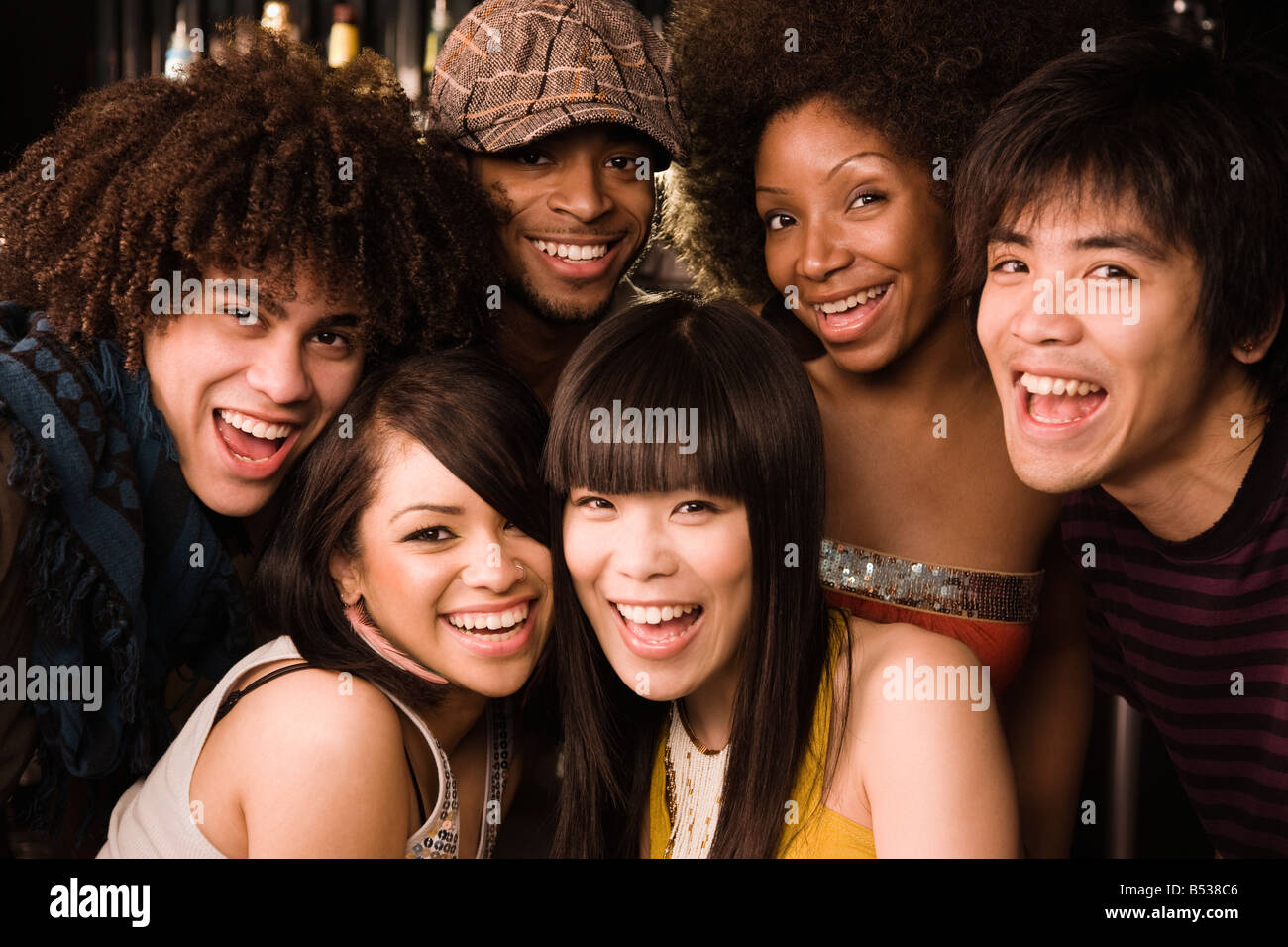 Multi-ethnic friends posing in nightclub Stock Photo - Alamy