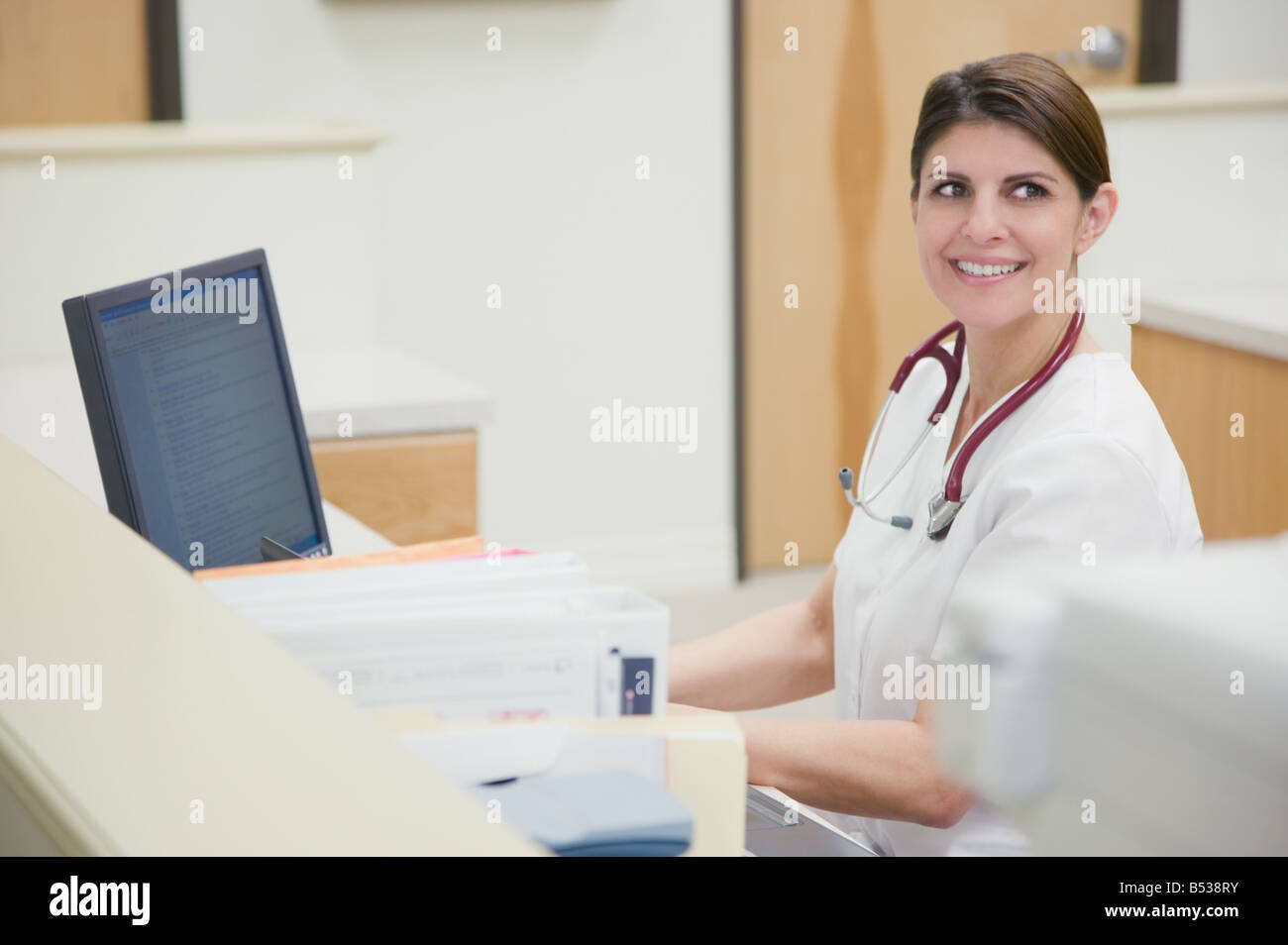 Nurse working at nurse’s station Stock Photo - Alamy