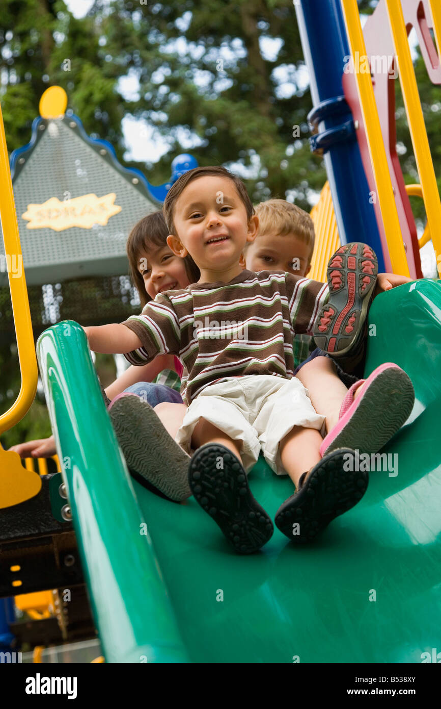 Children sliding in playground Stock Photo - Alamy