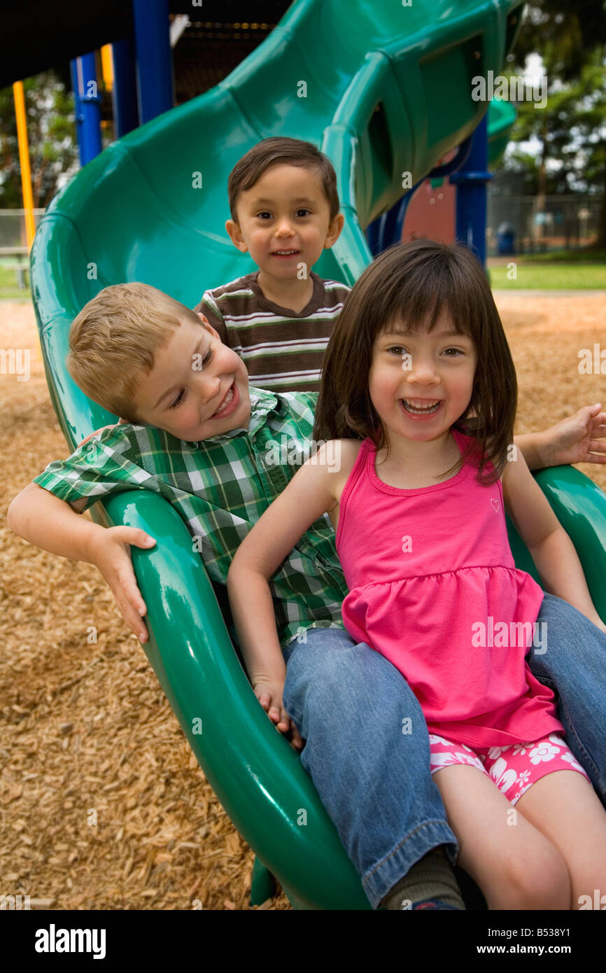 Children sliding in playground Stock Photo - Alamy
