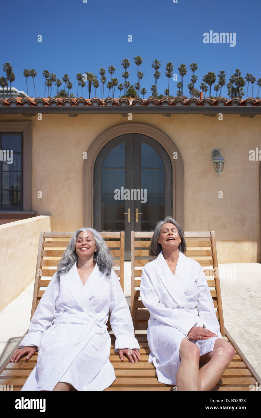 Woman laying on patio chairs hi-res stock photography and images - Alamy