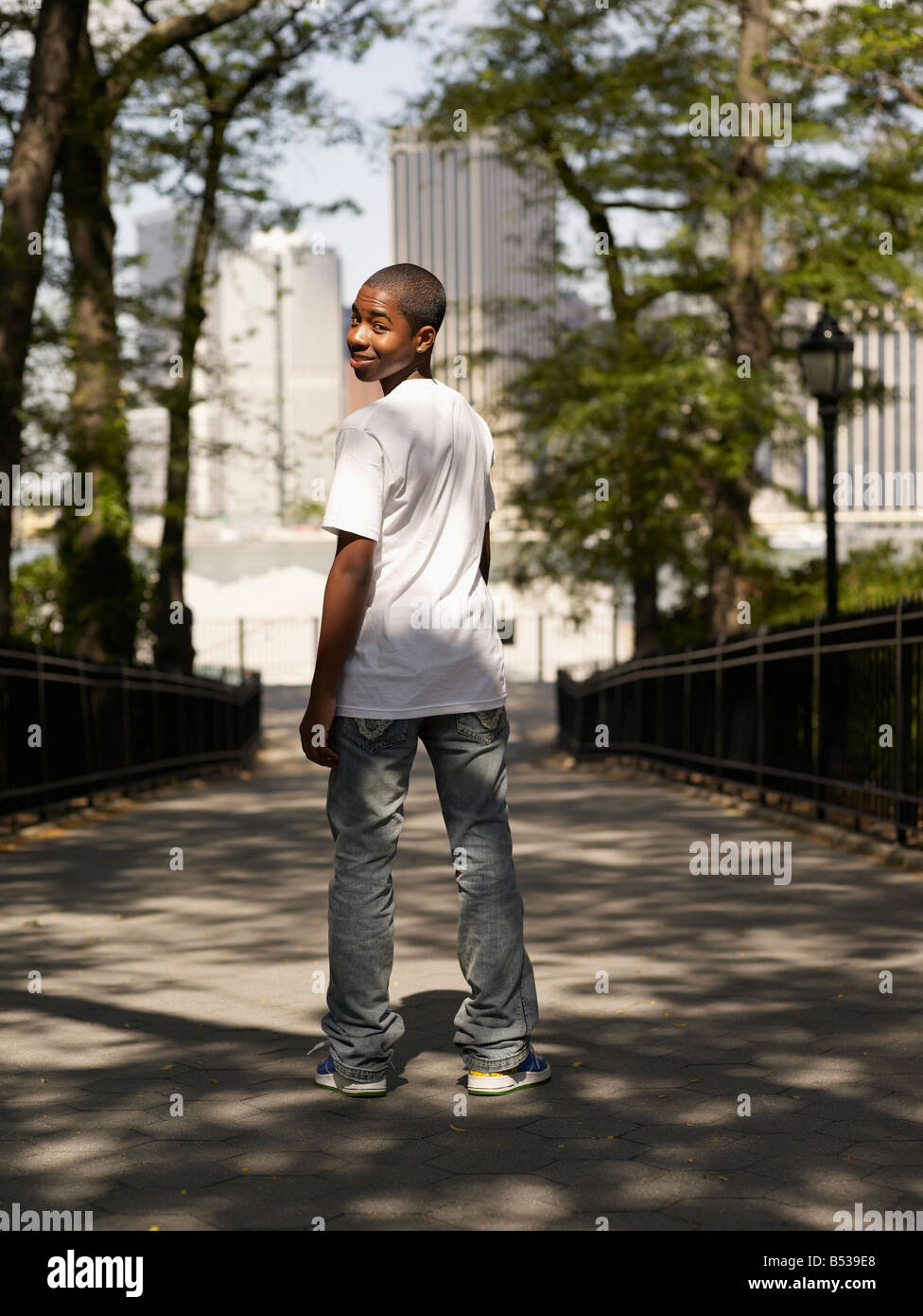 African teenage boy standing in urban park Stock Photo - Alamy