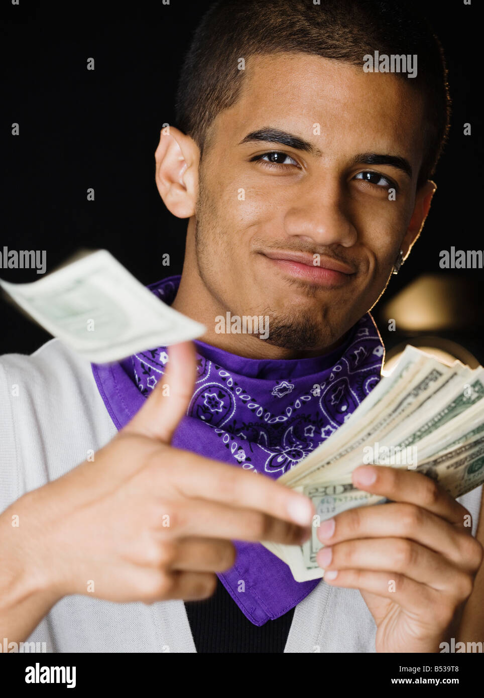 Hispanic teenage boy throwing money Stock Photo - Alamy