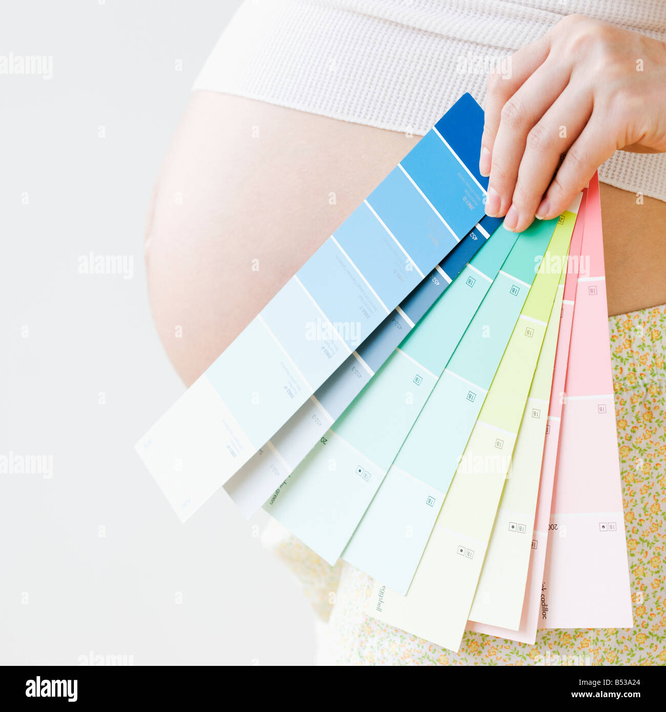 Pregnant Asian woman holding several color swatches Stock Photo - Alamy
