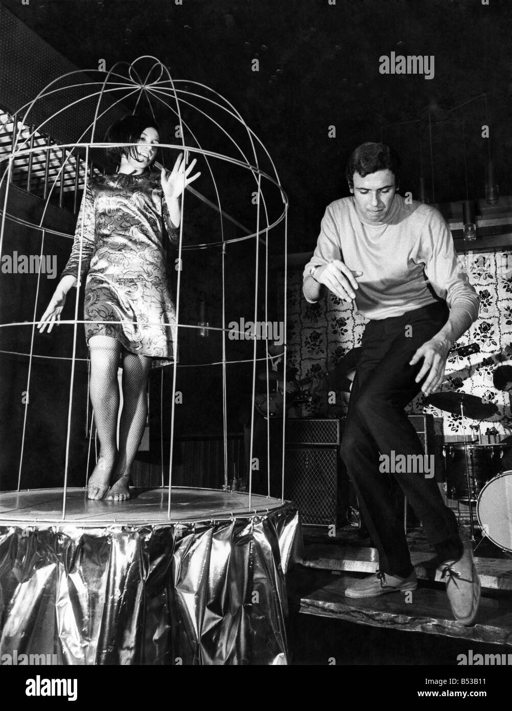 Caged dancer Pamela "Christian," one of the girls setting the cagebird ...