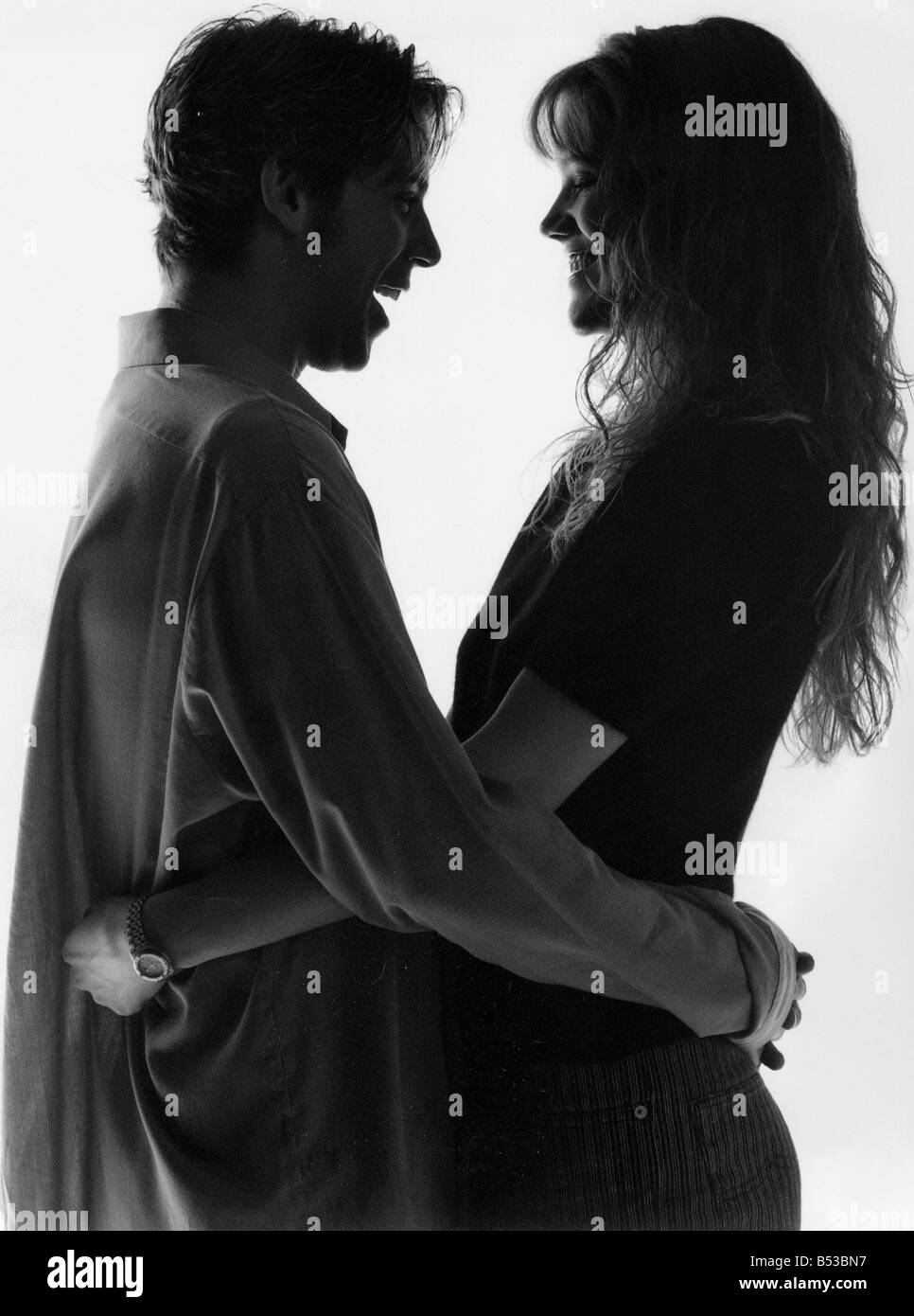 A couple enjoy a romantic cuddle Stock Photo - Alamy