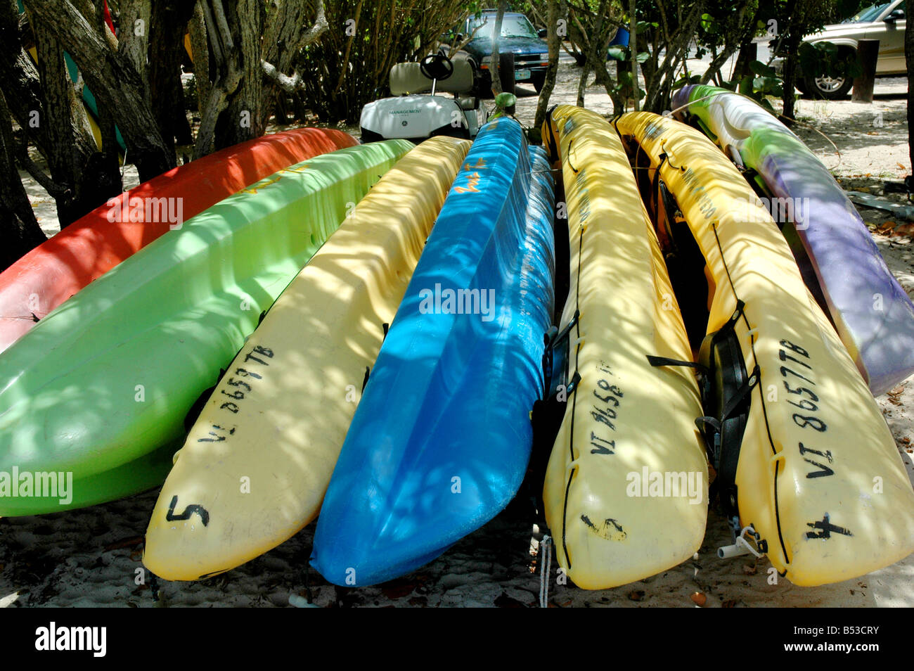kayaks for rent at megans bay st thomas stacked under a tree Stock ...