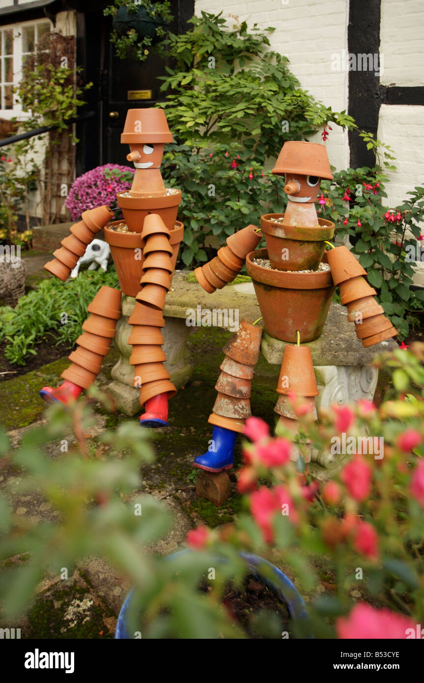 'Flower Pot Men' in a cottage garden in Shere, Surrey Stock Photo - Alamy