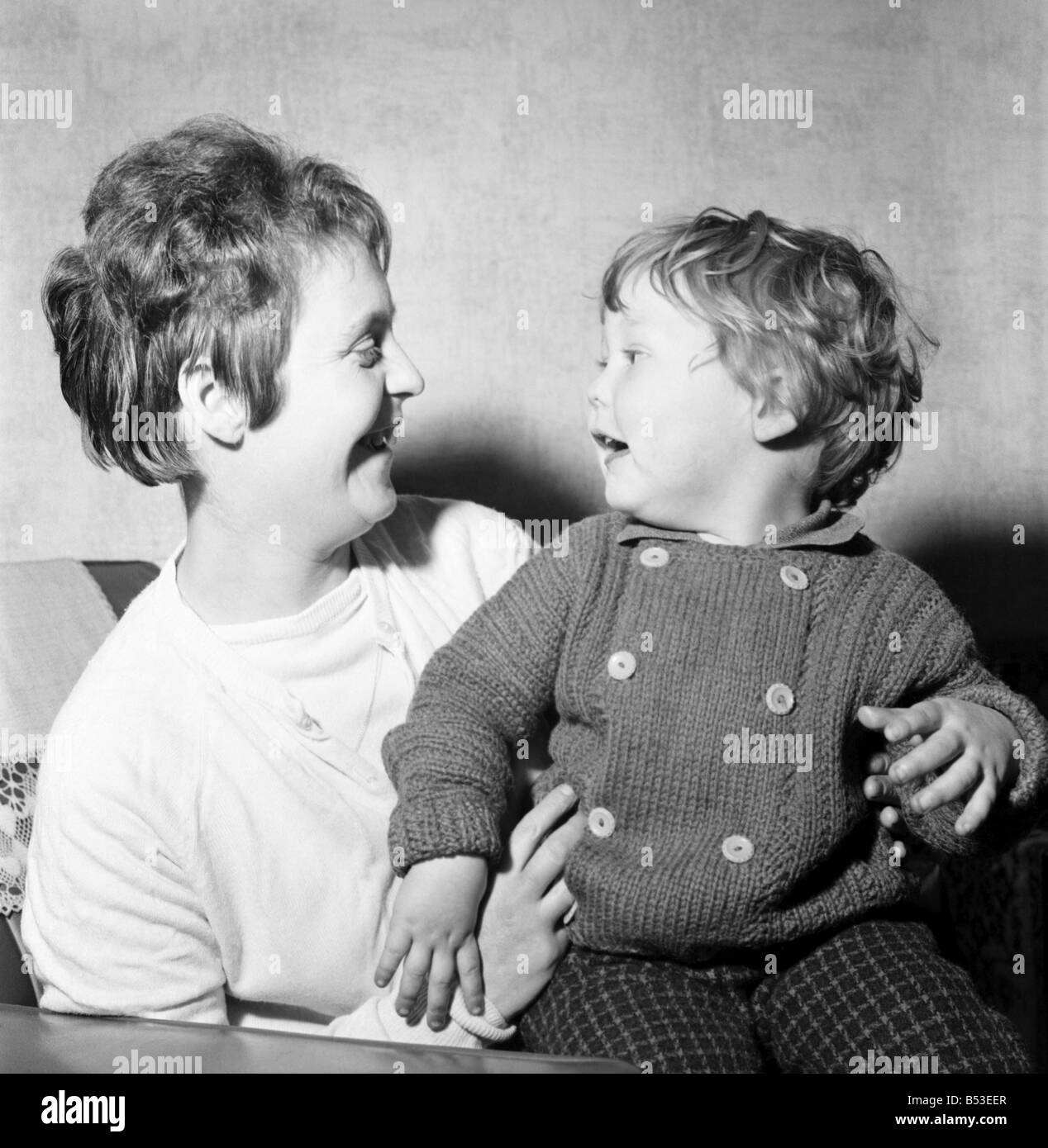 Little boy gets a kiss and a cuddle from his mother. November 1969 ...