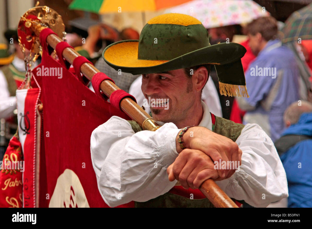 man carrying a flag with traditional costume during the Sarner Kirchtag ...