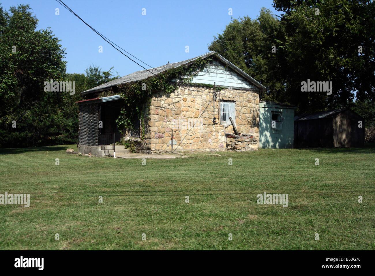 Small hand-built house made of native stone Stock Photo - Alamy