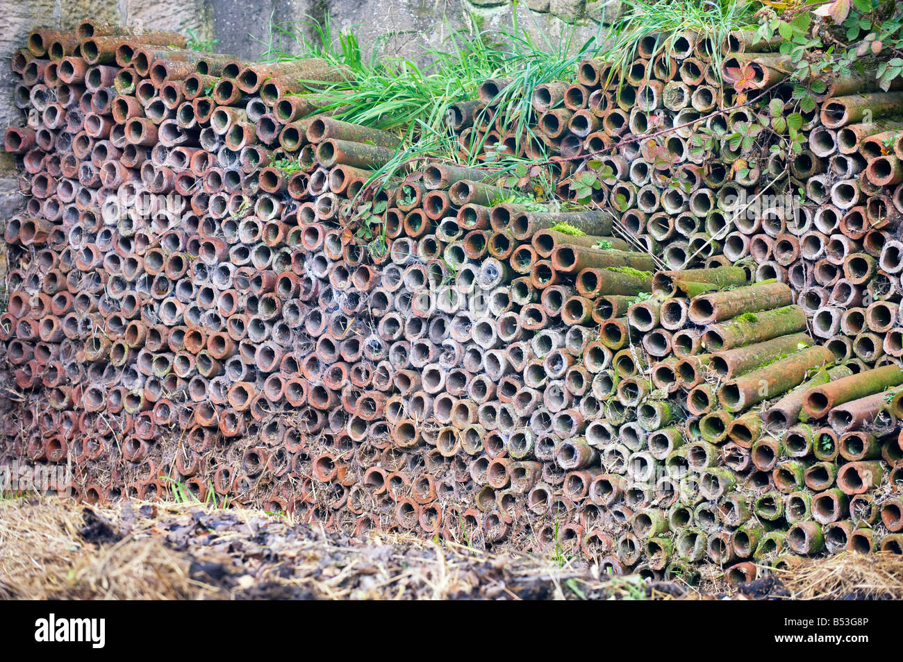 A stack of hand made terracotta land drains in a farmyard Stock Photo ...