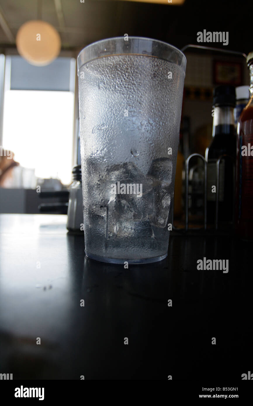 Empty plastic drinking glass with ice at bottom Stock Photo - Alamy