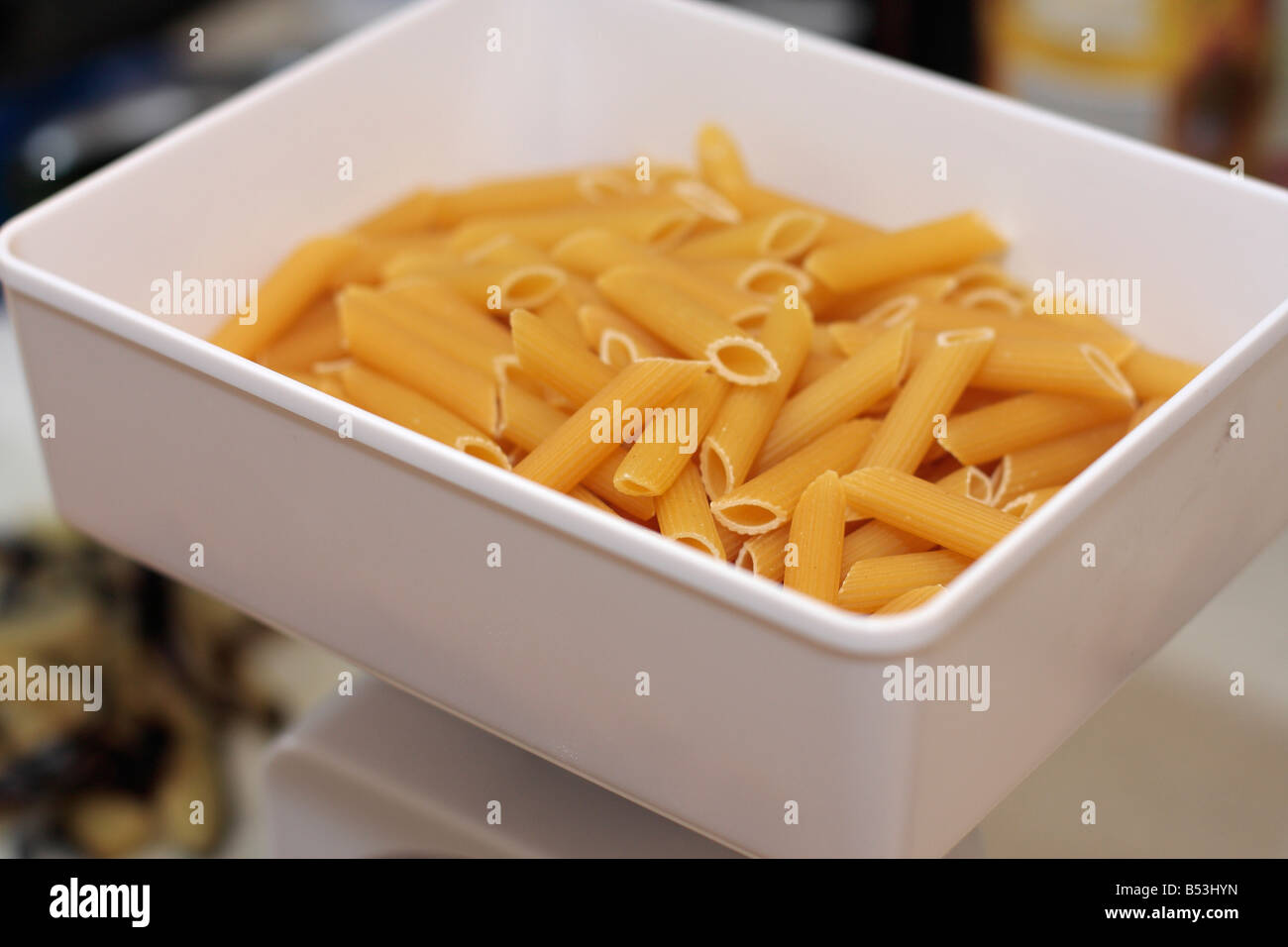 Penne Rigate pasta in a kitchen weighing scales Stock Photo - Alamy