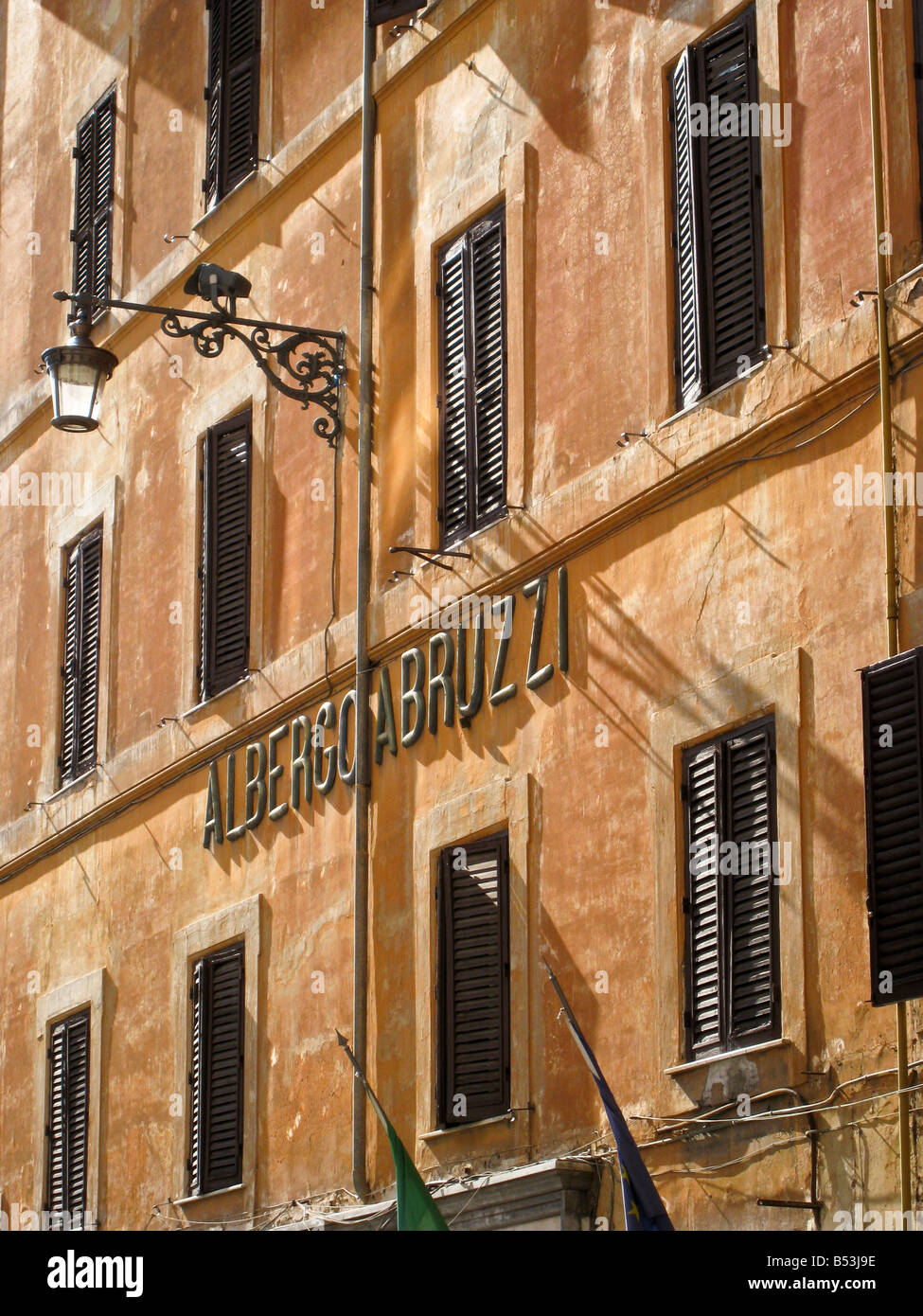Albergo Abruzzi hotel building with ocre wall and brown window shutters ...