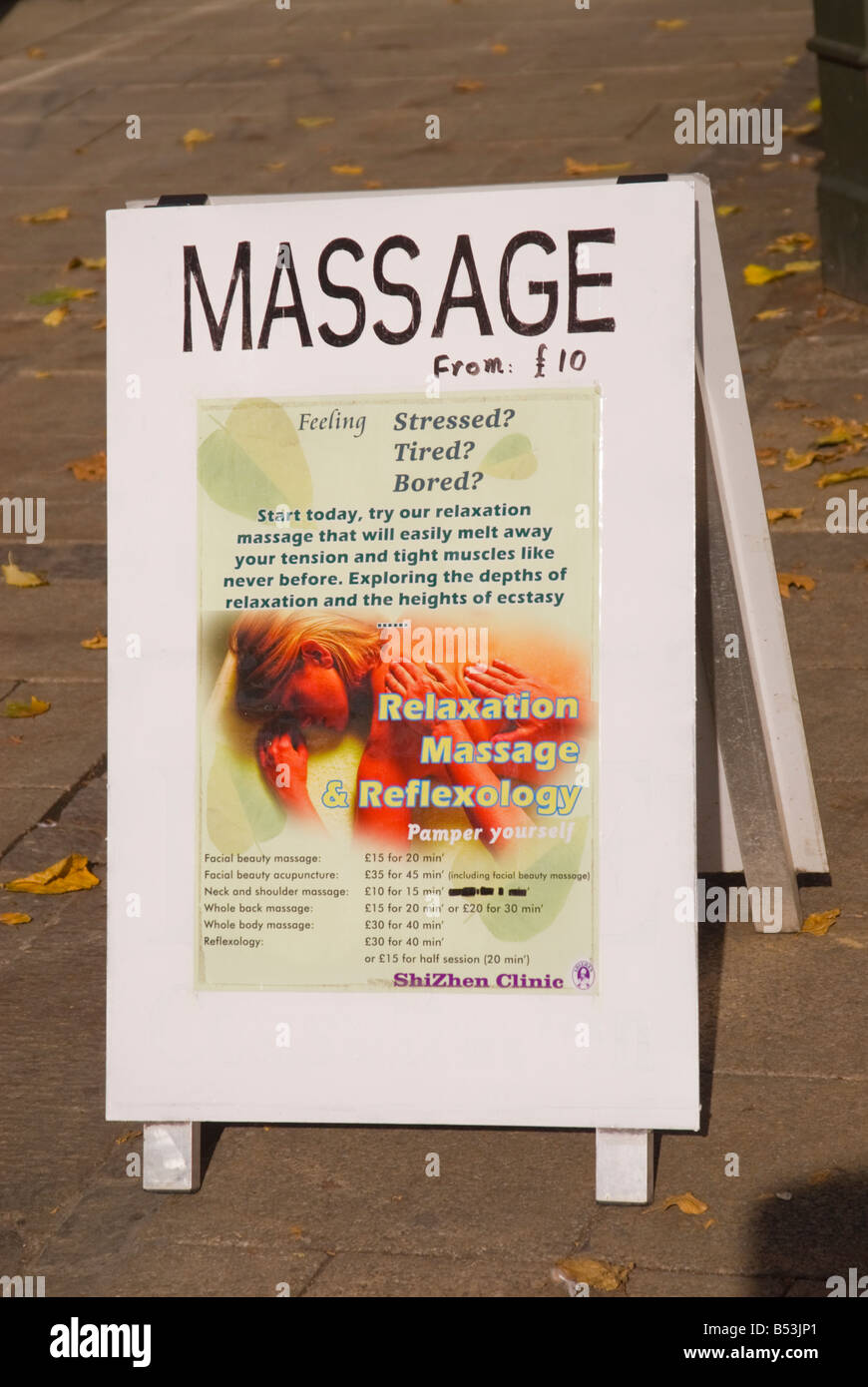 Sign outside shop advertising massage and reflexology starting at £10 ...
