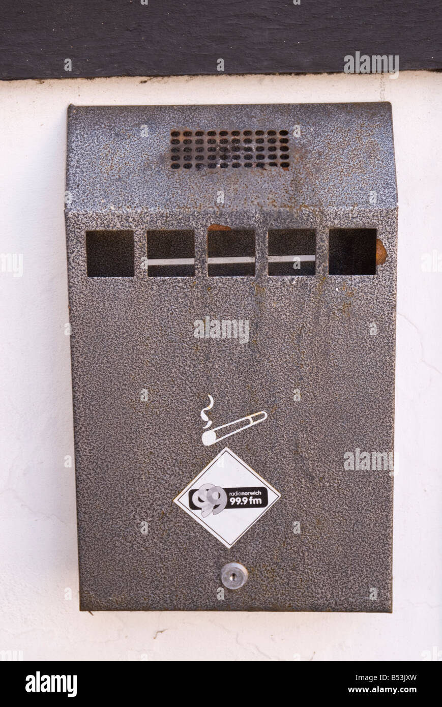 Metal box (ash tray) on wall outside uk pub to put cigarettes in due to ...