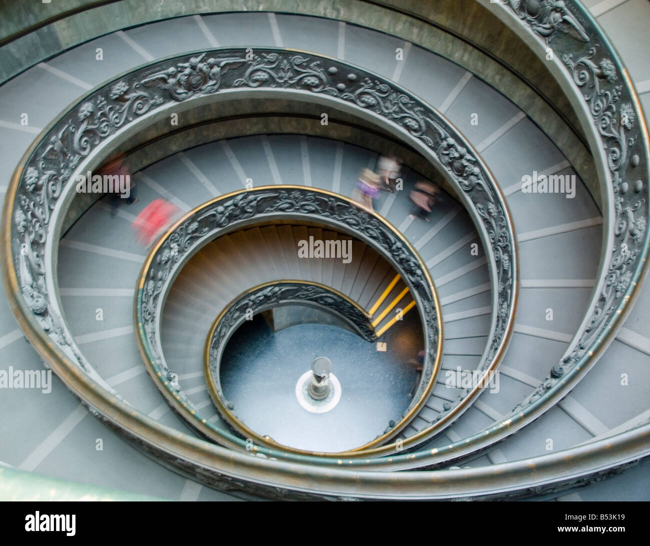 Red tourist rushing down spiral staircase Stock Photo - Alamy