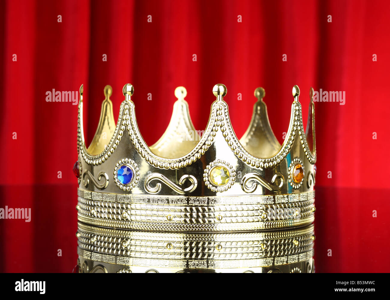 Crown with red curtain background Stock Photo - Alamy