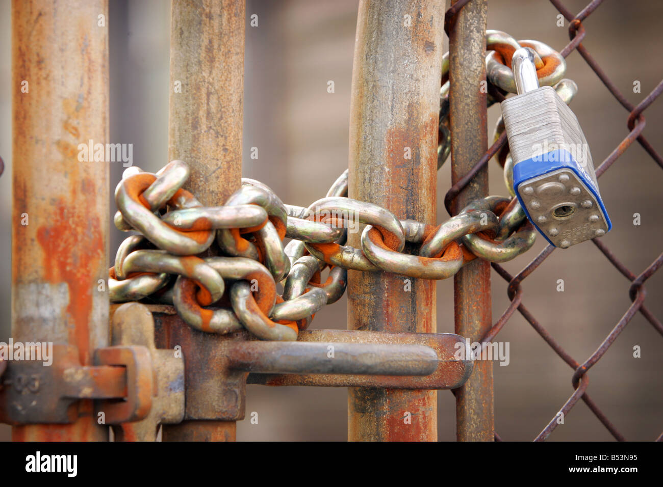 An old rusted length of chain wrapped around the poles of a gate and ...