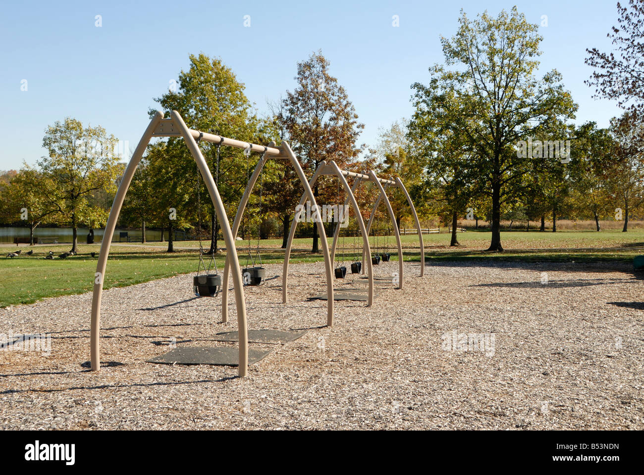 empty swing set on playground in fall Stock Photo - Alamy